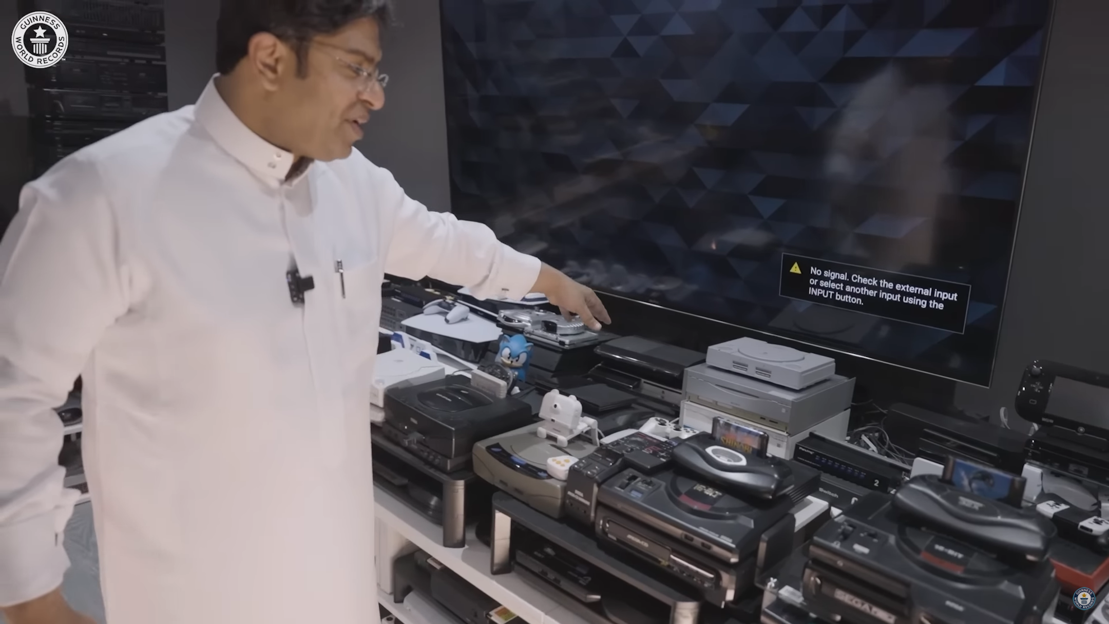 A console collector broke a world record with 444 consoles attached to one TV